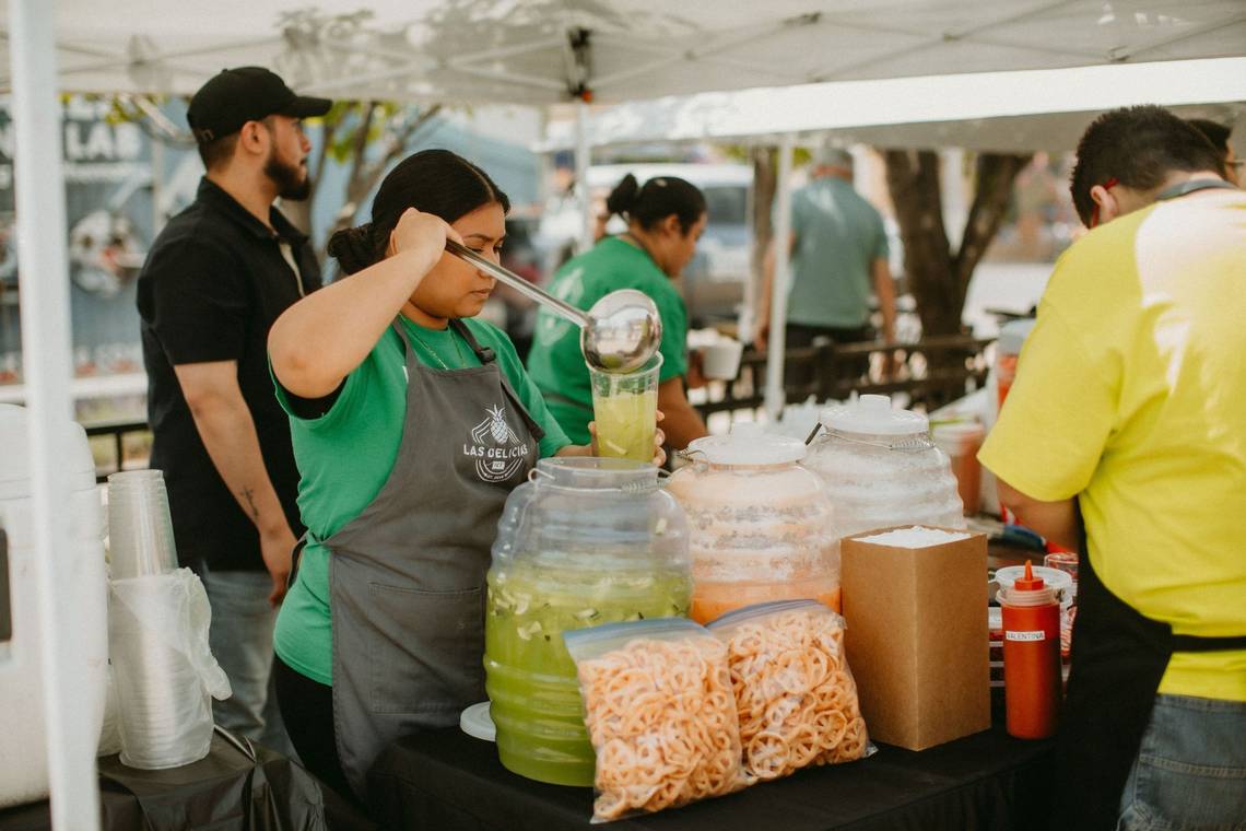 A big fiesta, street party with Hispanic food, drink, music happens ...