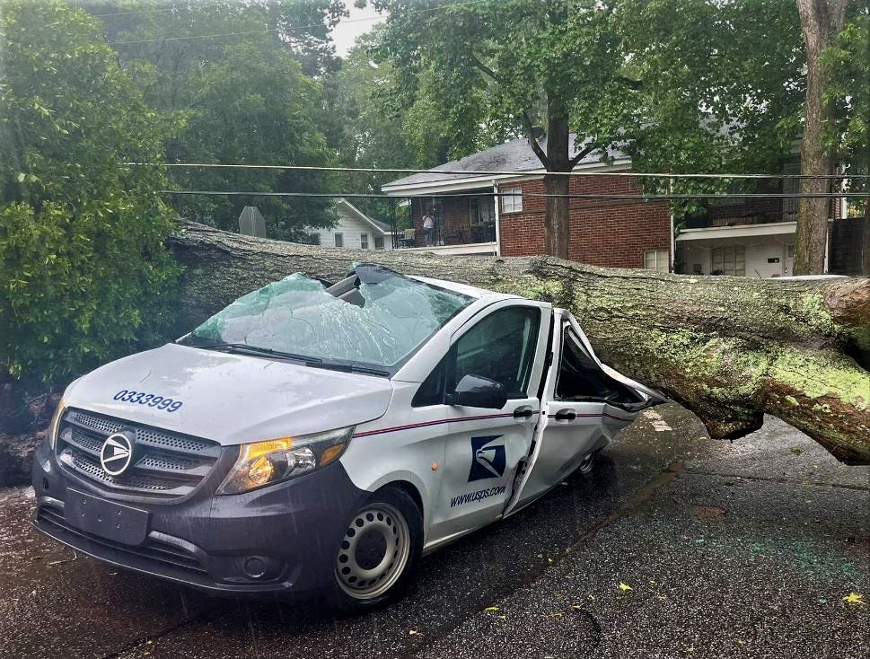 Huge oak tree falls on U.S. Post Office delivery truck in Athens