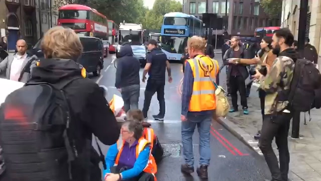 Angry commuter attacks Just Stop Oil protesters as they block street in ...